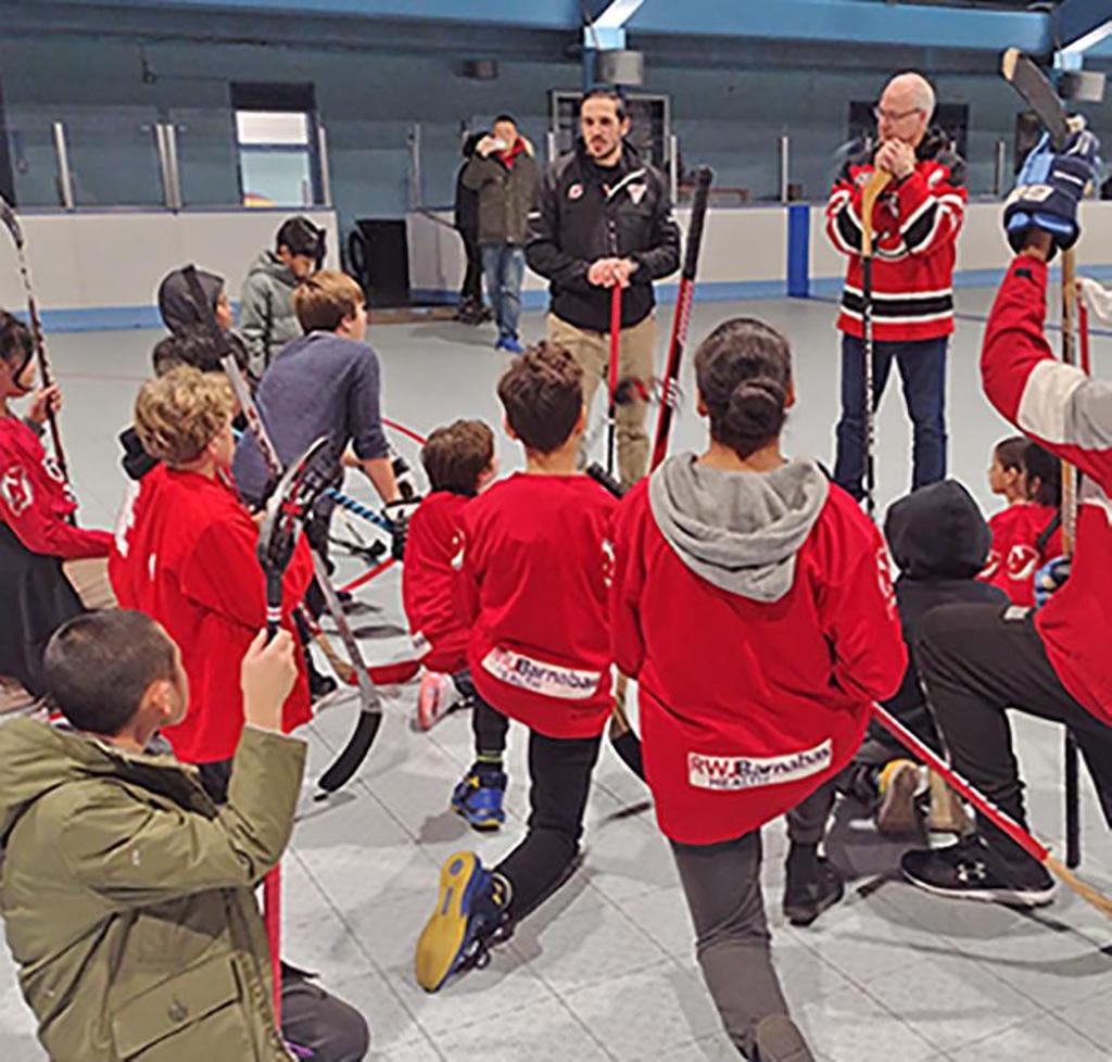 Bruce Driver works with ball hockey participants